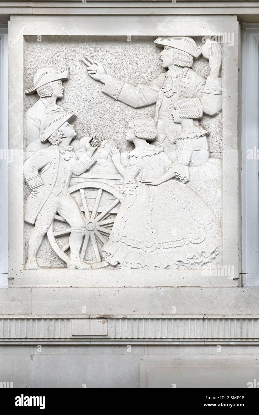 18th century AD style costumes in a sculpture on a 1933 building, the ...