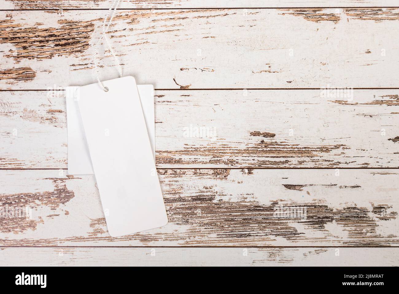 white Blank tag on a light wooden background Stock Photo - Alamy
