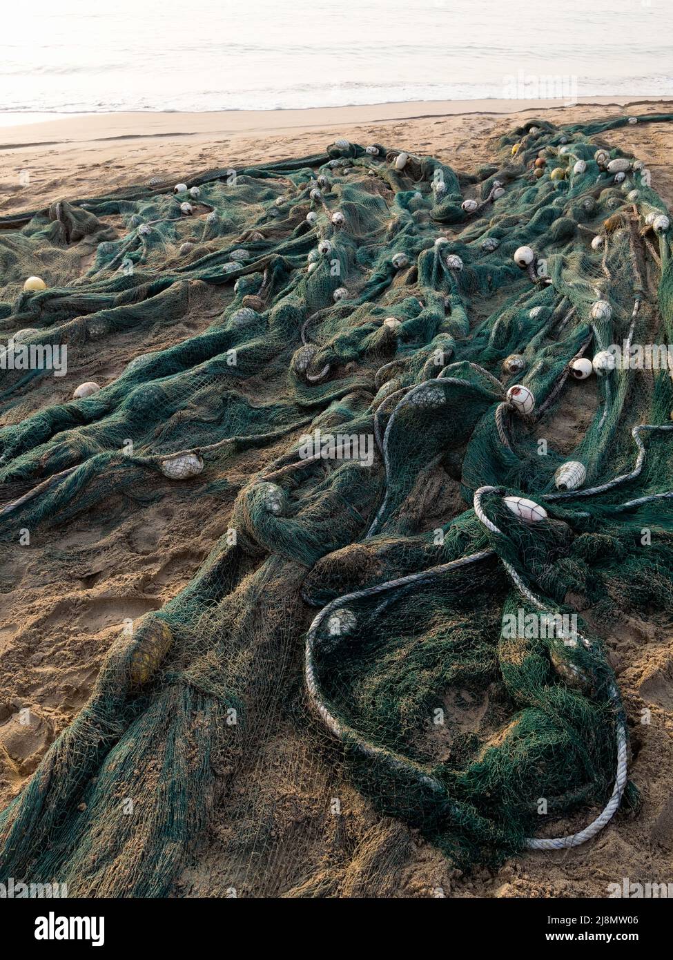 Discarded fishing net on the beach. Marine pollution concept Stock ...