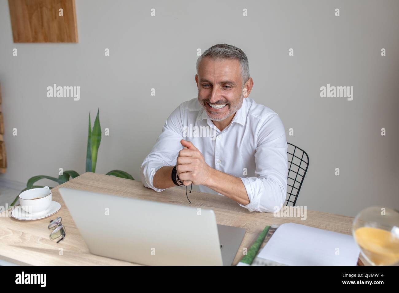 Happy man looking at laptop screen Stock Photo - Alamy