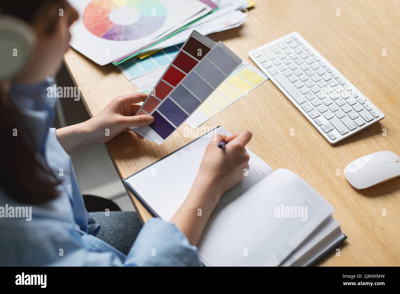 Portrait Of Female Asian Designer Writing In Notebook Stock Photo - Alamy