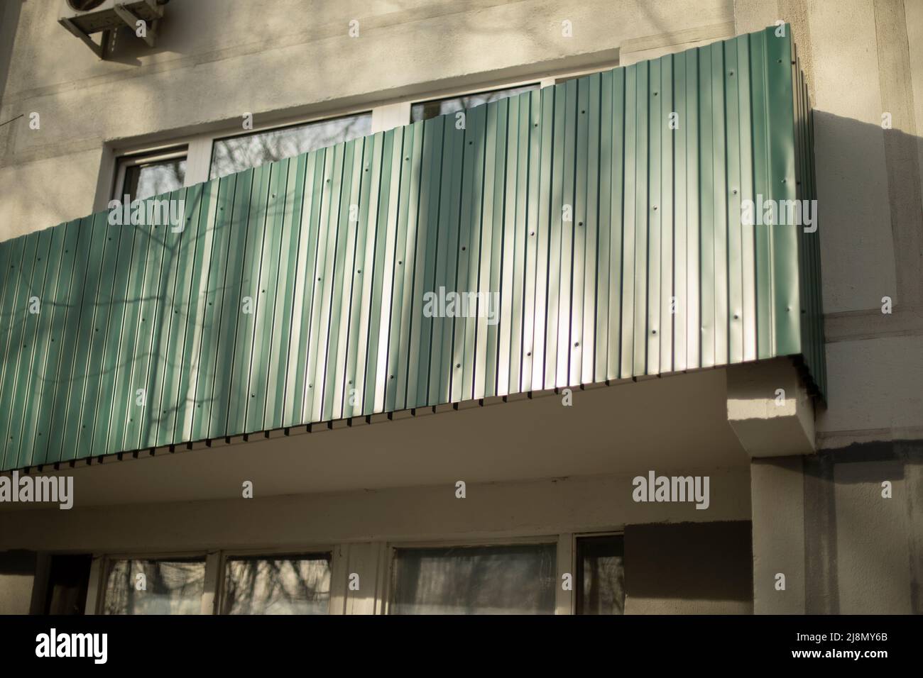 Balconies in residential building. Metal profile is green. Balcony ...