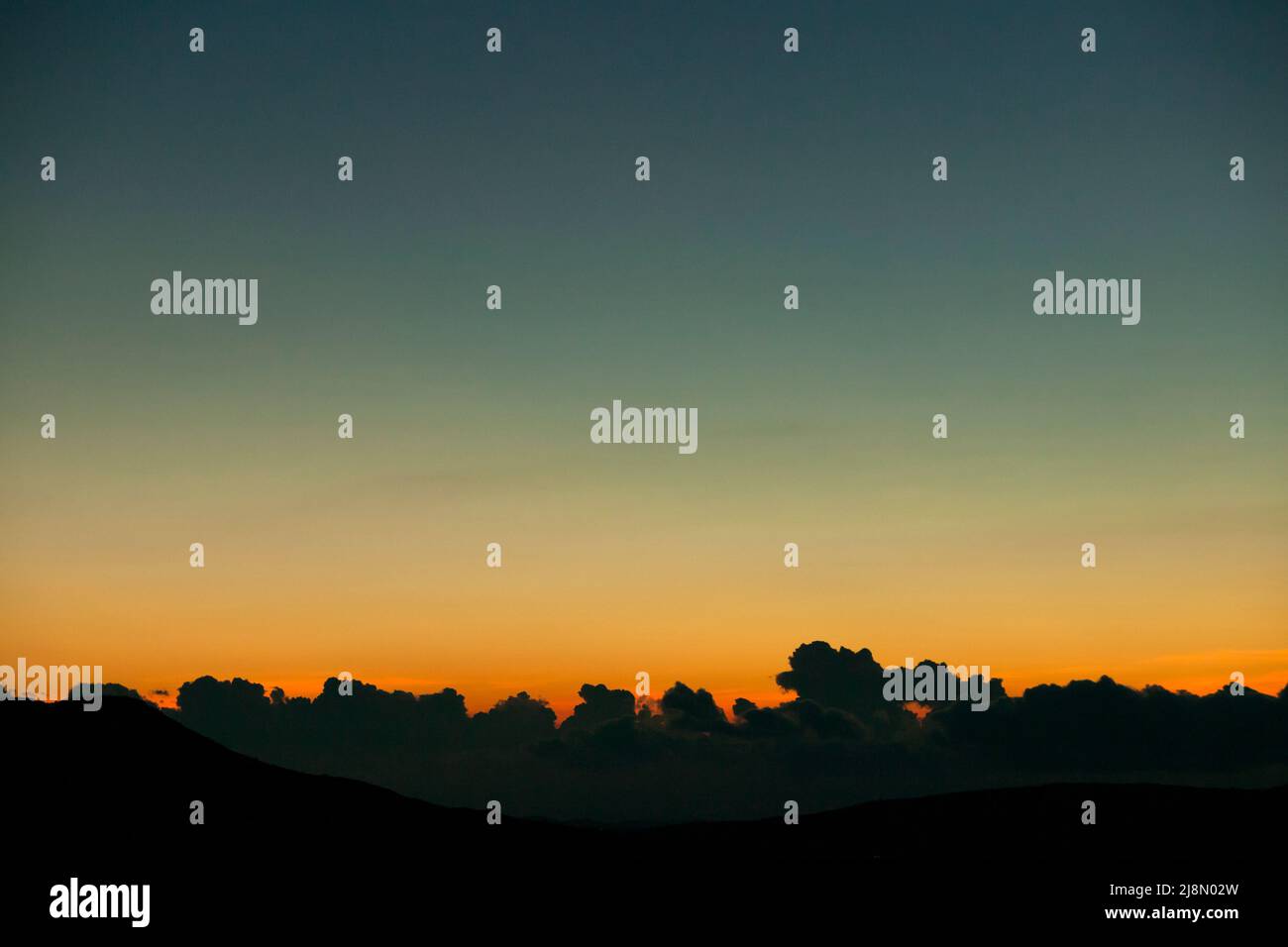 Vivid colours of a winter sunset, with low cumulus clouds on the ...