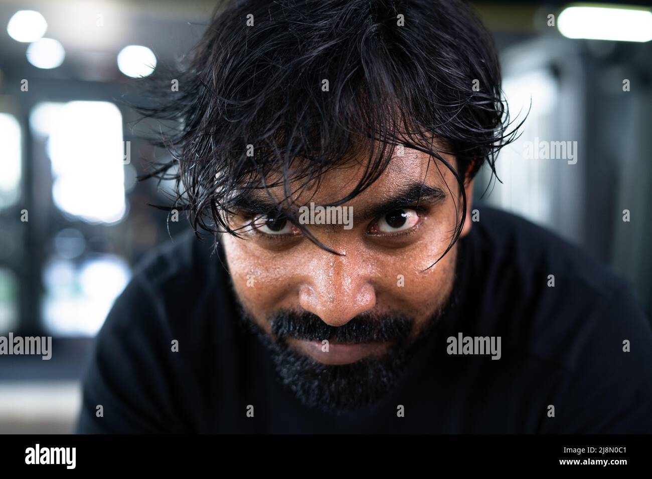 Close up head shot of serous athlete rising head by looking camera at ...