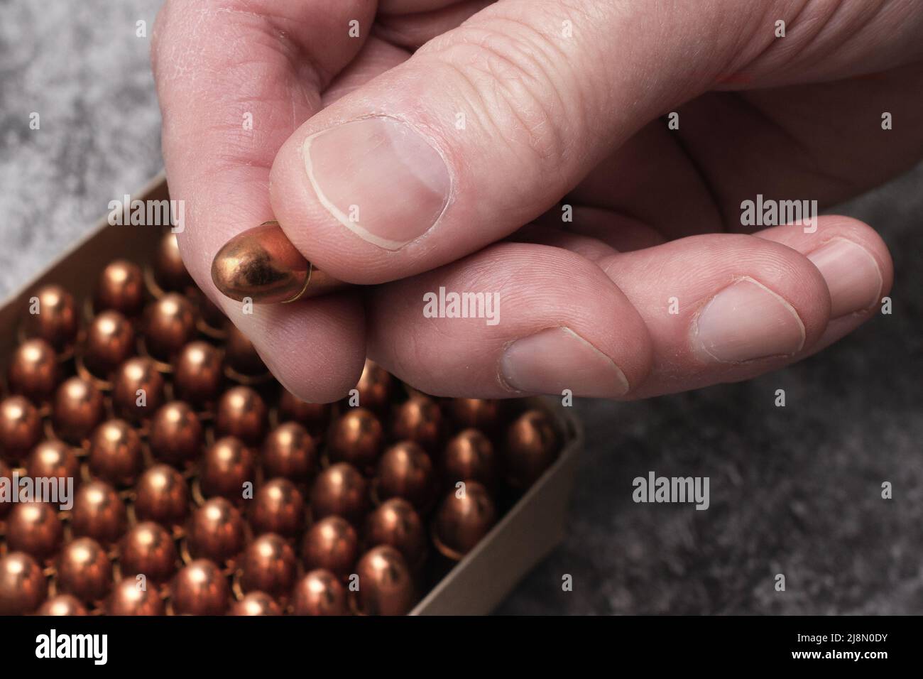 Hand holding bullet hi-res stock photography and images - Alamy