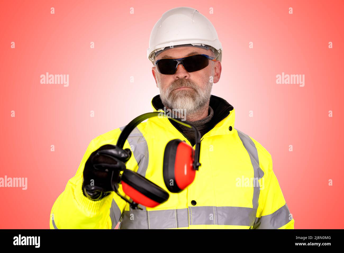 A construction worker in a white hat, yellow hi-viz coat and dark ...
