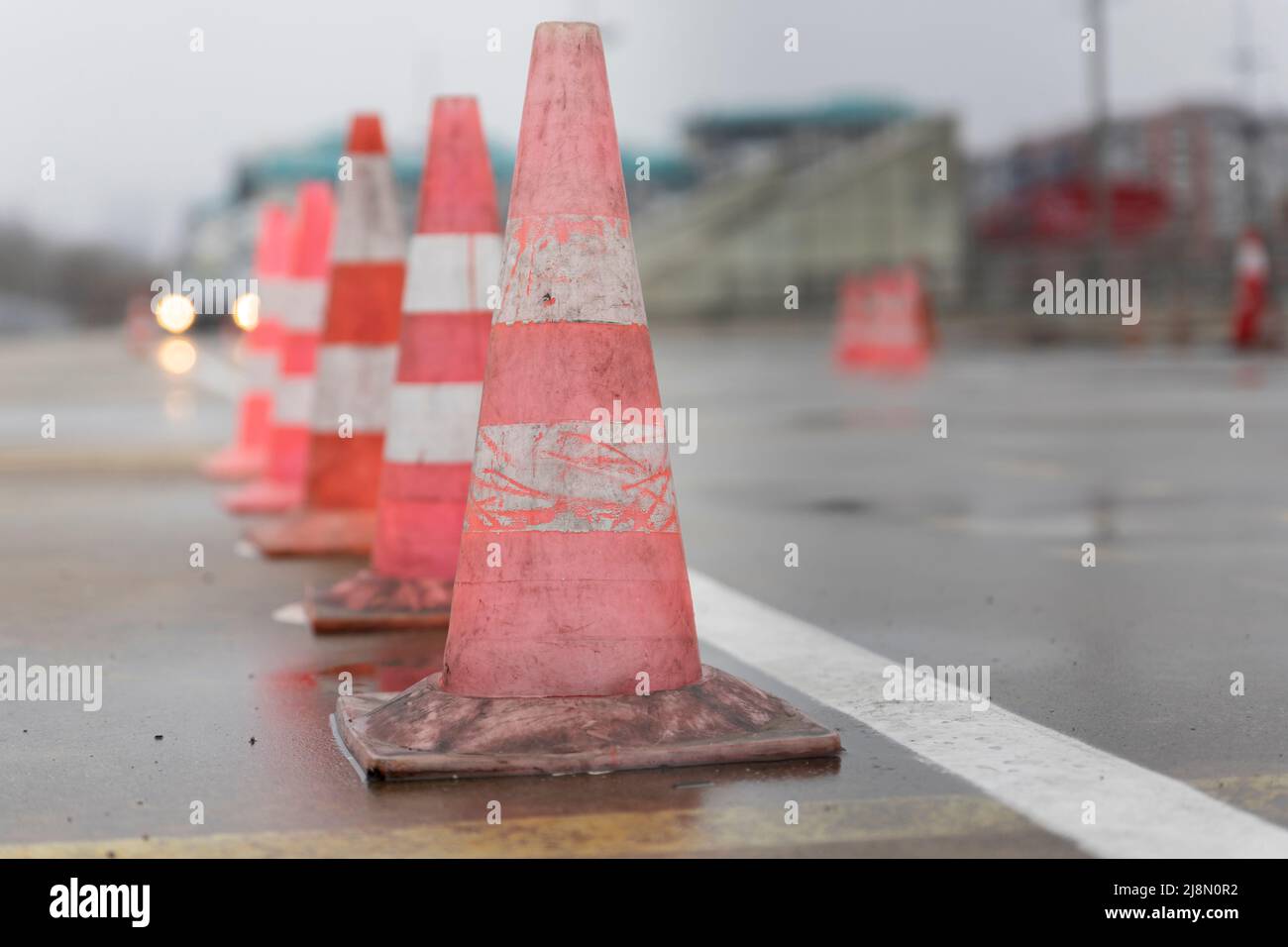 Traffic cones on the wet road. Caution ,danger, warning signs Stock ...