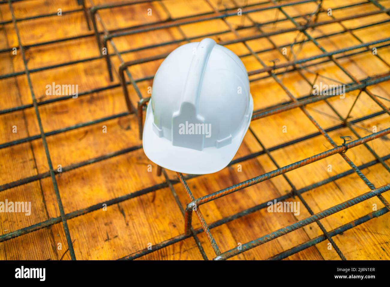 WHITE construction helmet at the construction site Stock Photo - Alamy