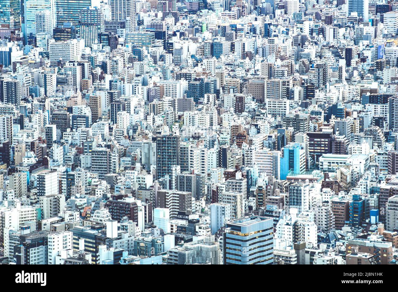 Zoom detail close up of Tokyo city skyline from above at blue hour ...