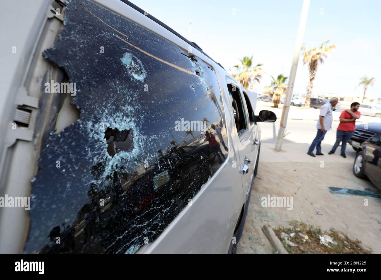 Tripoli, Libya. 17th May, 2022. Damaged cars are seen after clashes in ...