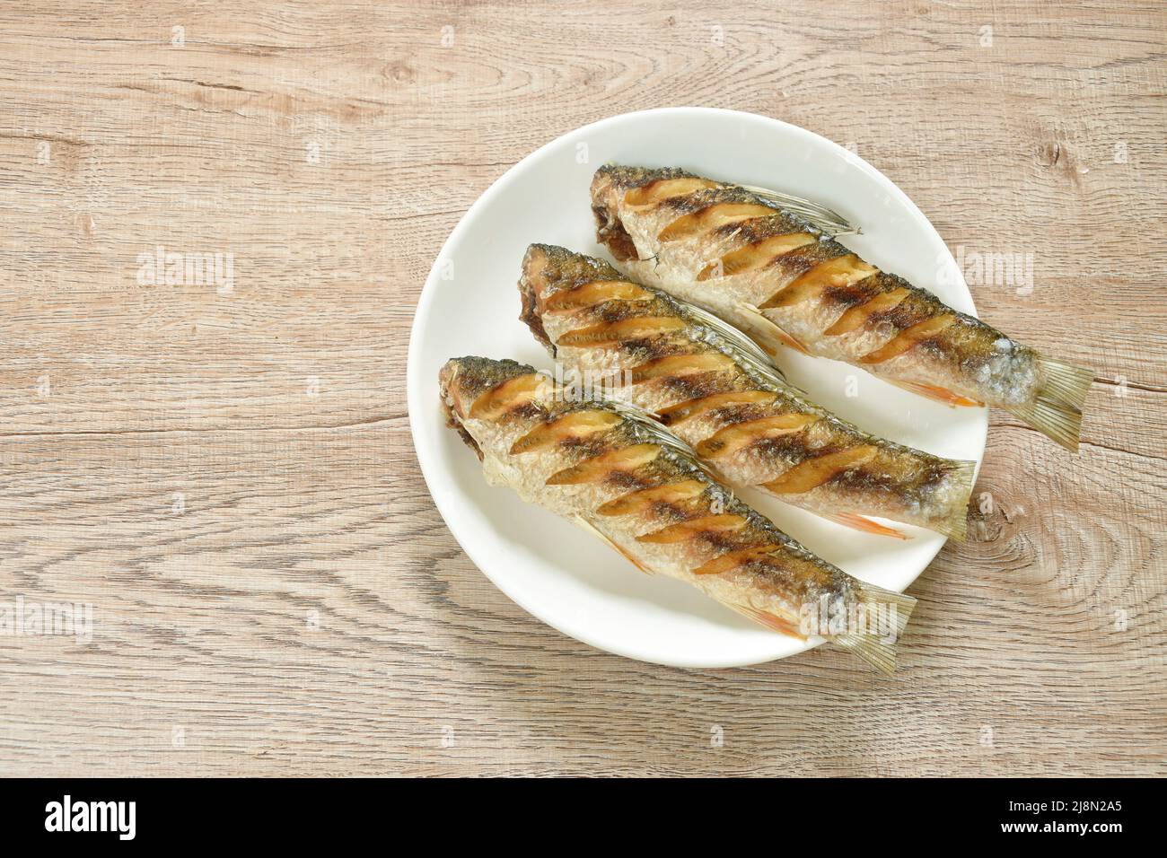 deep fried salty mullet fish arranging on plate Stock Photo - Alamy