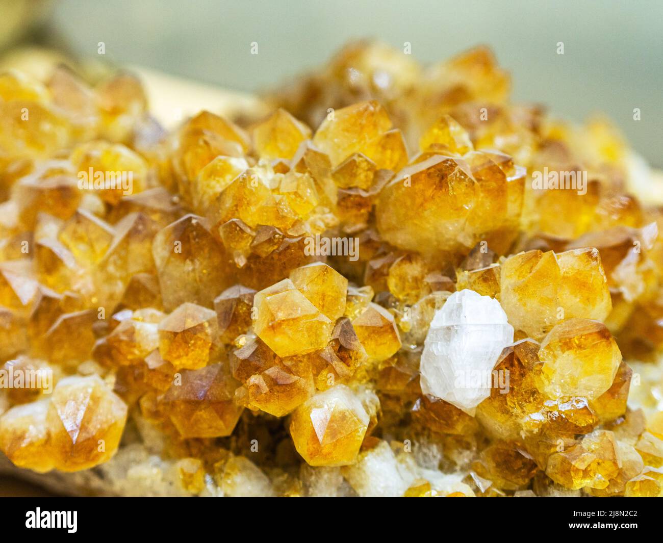 Raw specimen of quartz crystal stone. Citrine yellow gem crystals geological mineral background ...