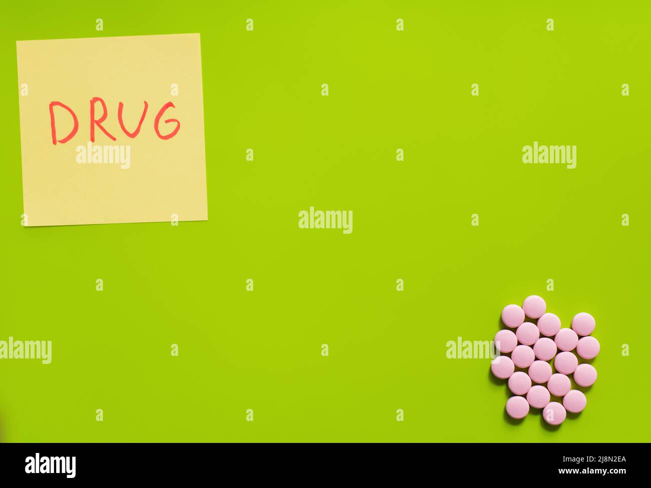 top view of pink round shape medication near paper note with drug ...