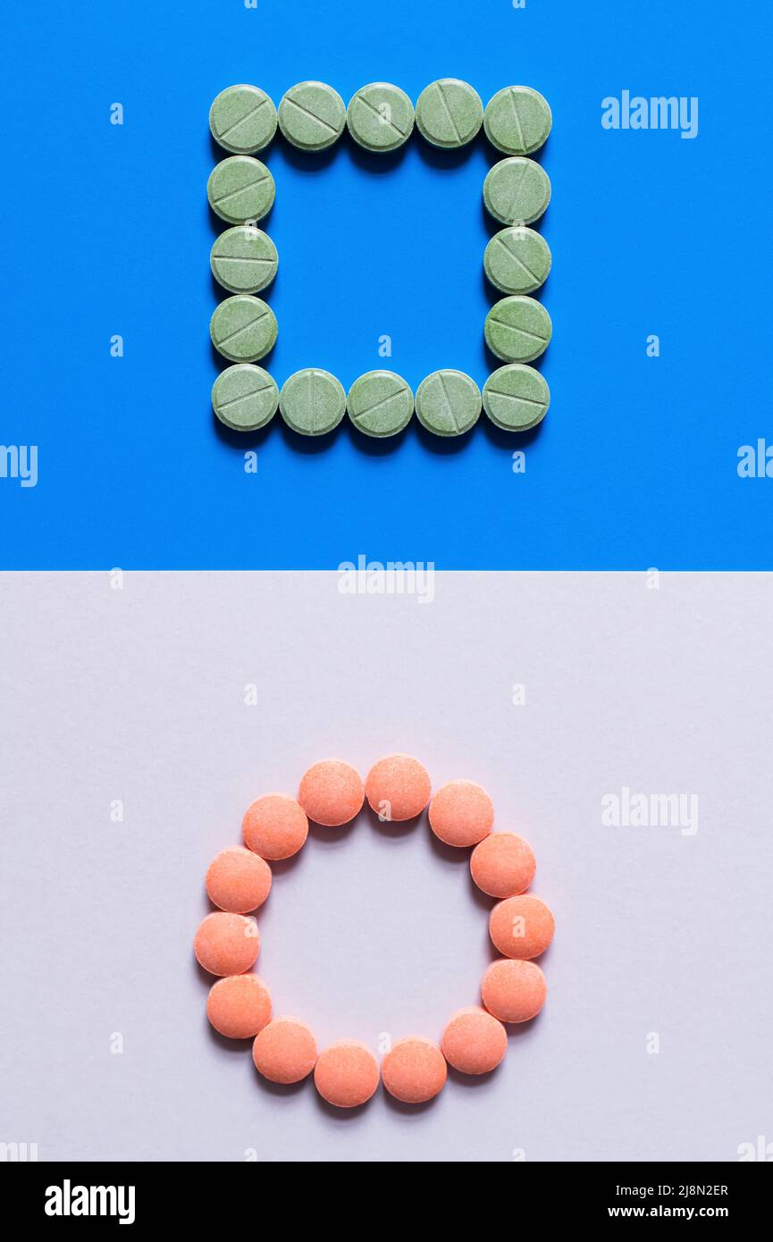 top view of pills in shapes of circle and square on white and blue ...