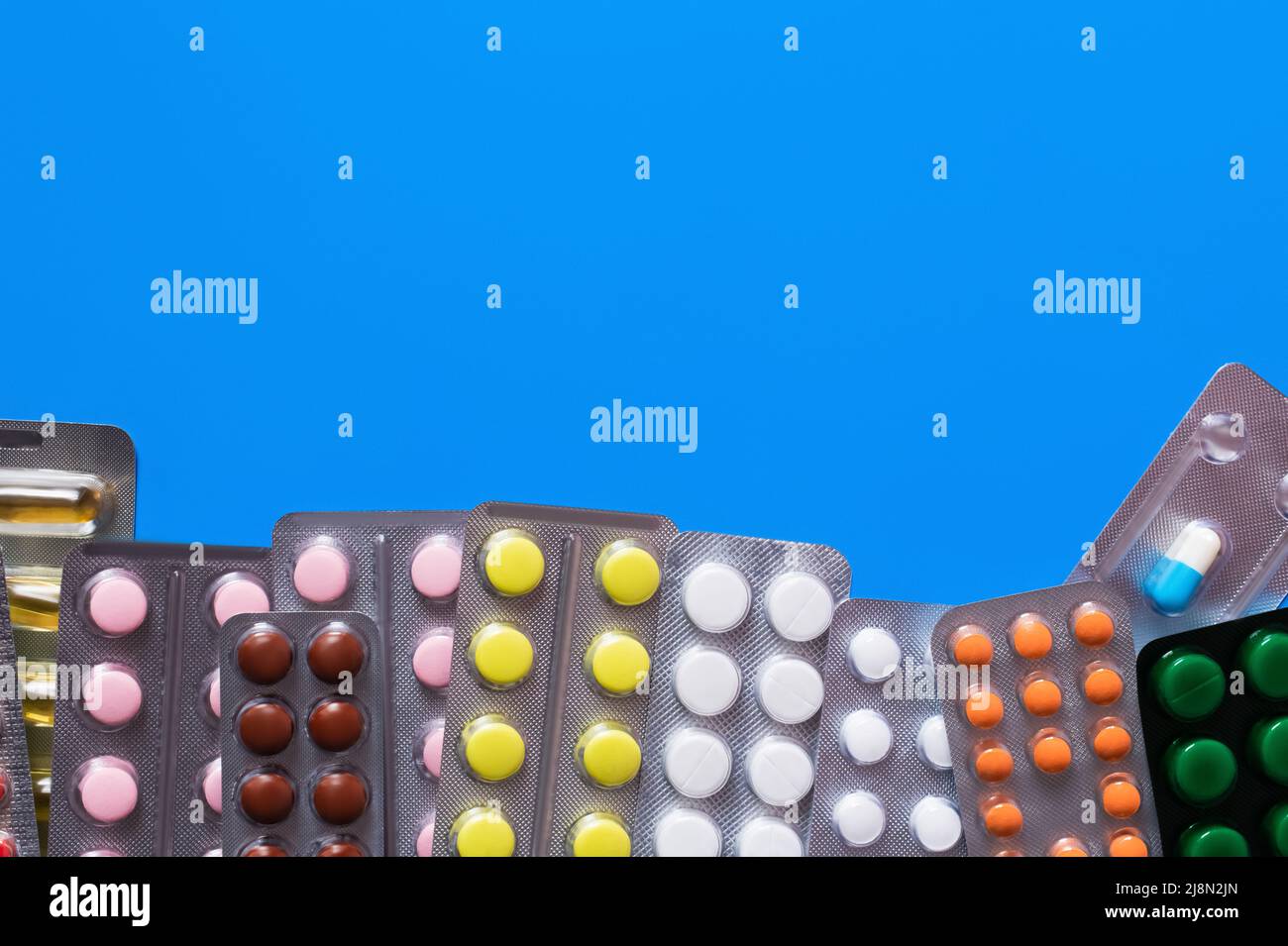 top view of blister packs with different pills isolated on blue Stock ...