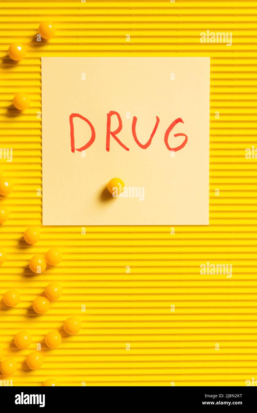 top view of round shape medication near paper note with drug lettering ...