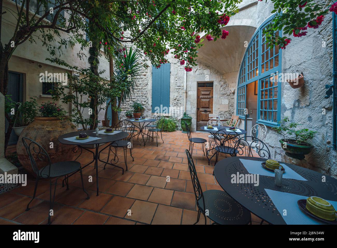 Provence style vintage courtyard with flowers and trees Stock Photo - Alamy