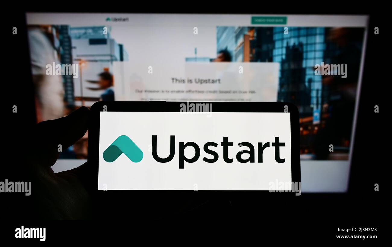 Person holding cellphone with logo of US fintech company Upstart ...