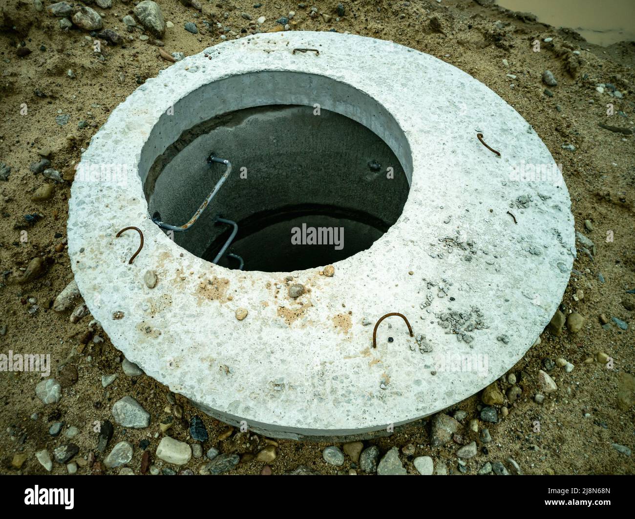 Dug-in concrete well rings with a concrete cover. Plumbing and sewerage ...