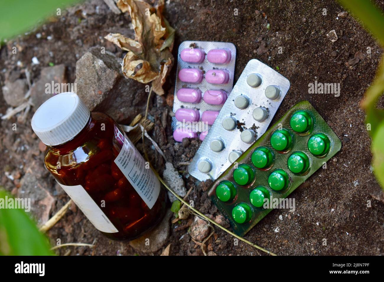 Dirty drugs on the ground. Expired medicine. Closeup view Stock Photo ...