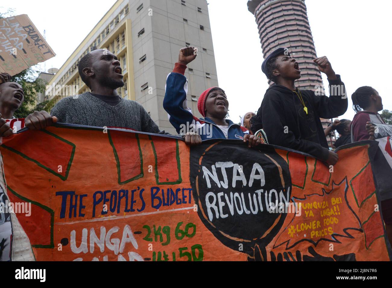 Protesters chant slogans while holding a banner during the ...