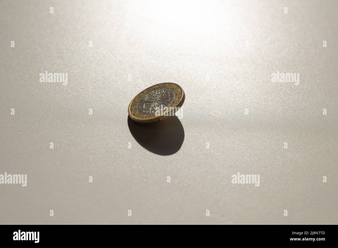 Coin spinning in slow motion on a white background Stock Photo - Alamy
