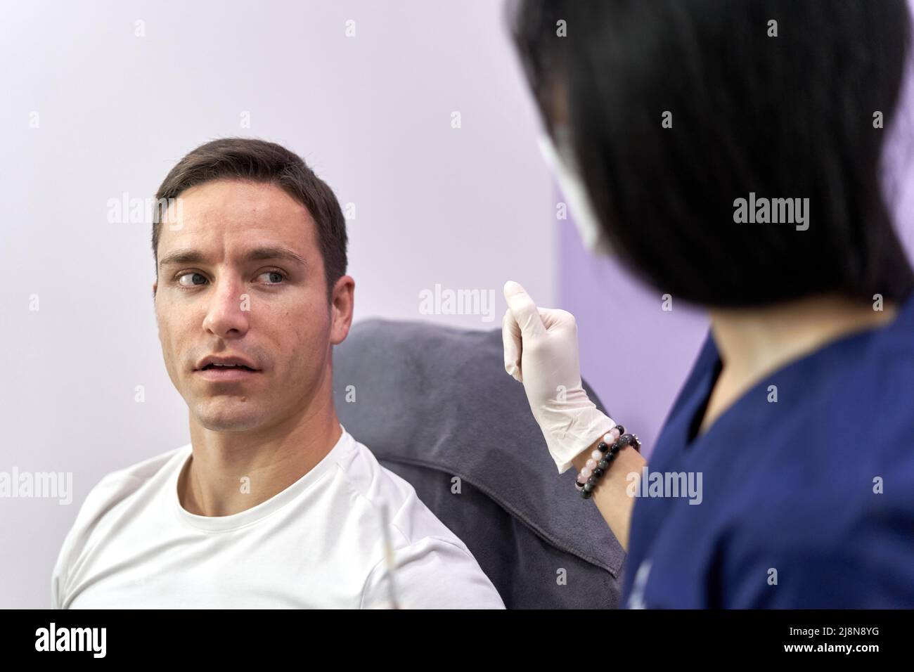 Patient listening attentively to the instructions of a doctor in a ...