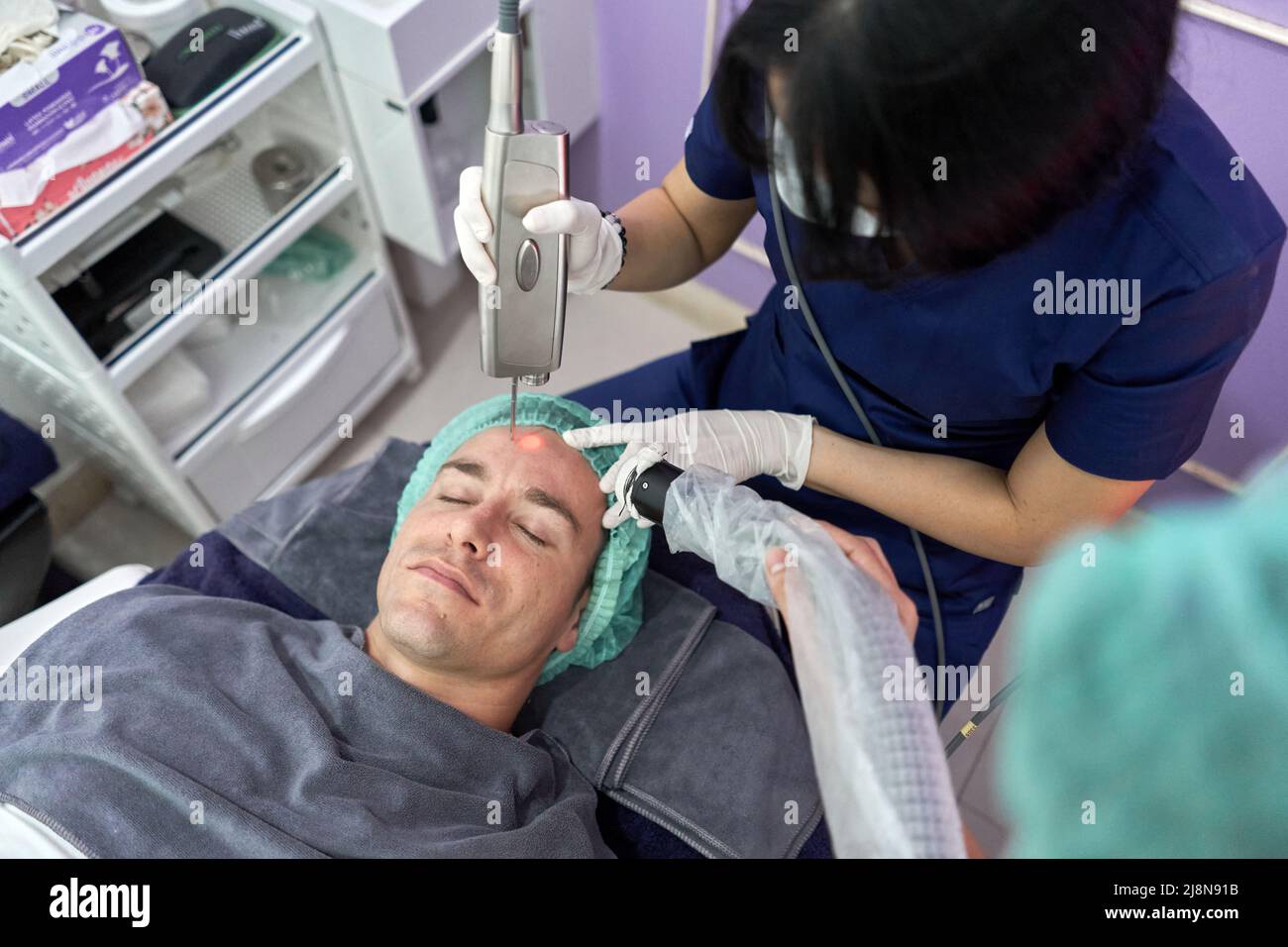 Patient receiving a laser treatment to rejuvenate the skin Stock Photo ...