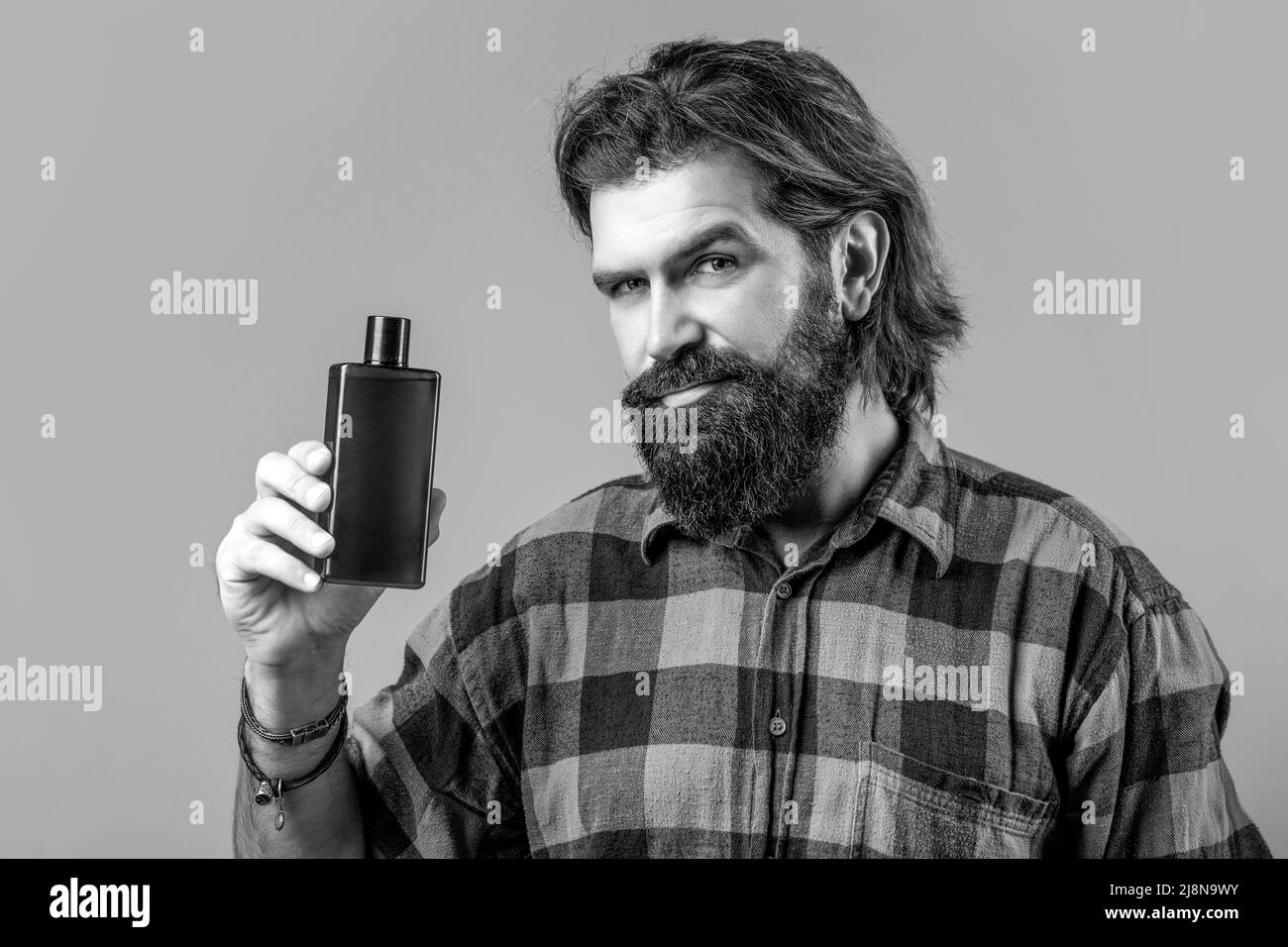 Expert care for demanding hair. Plastic container with shampoo. Young ...