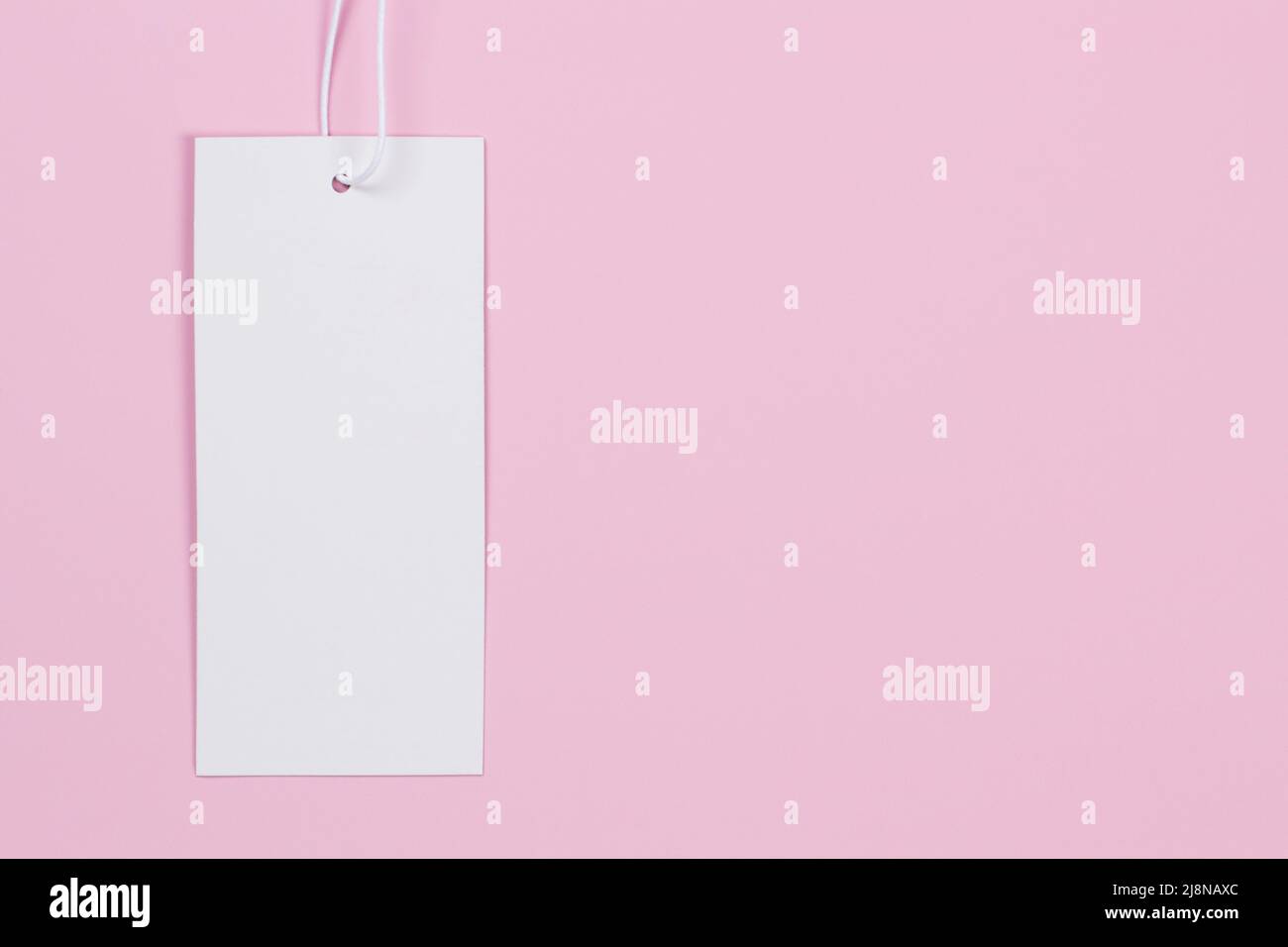 Blank white rectangular label tag on pastel pink background. Price tag ...