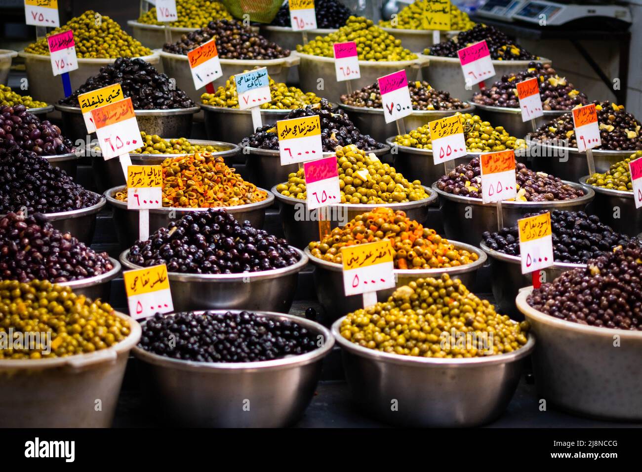 Variety of olives for sale on Suq (arabic price tags Stock Photo - Alamy