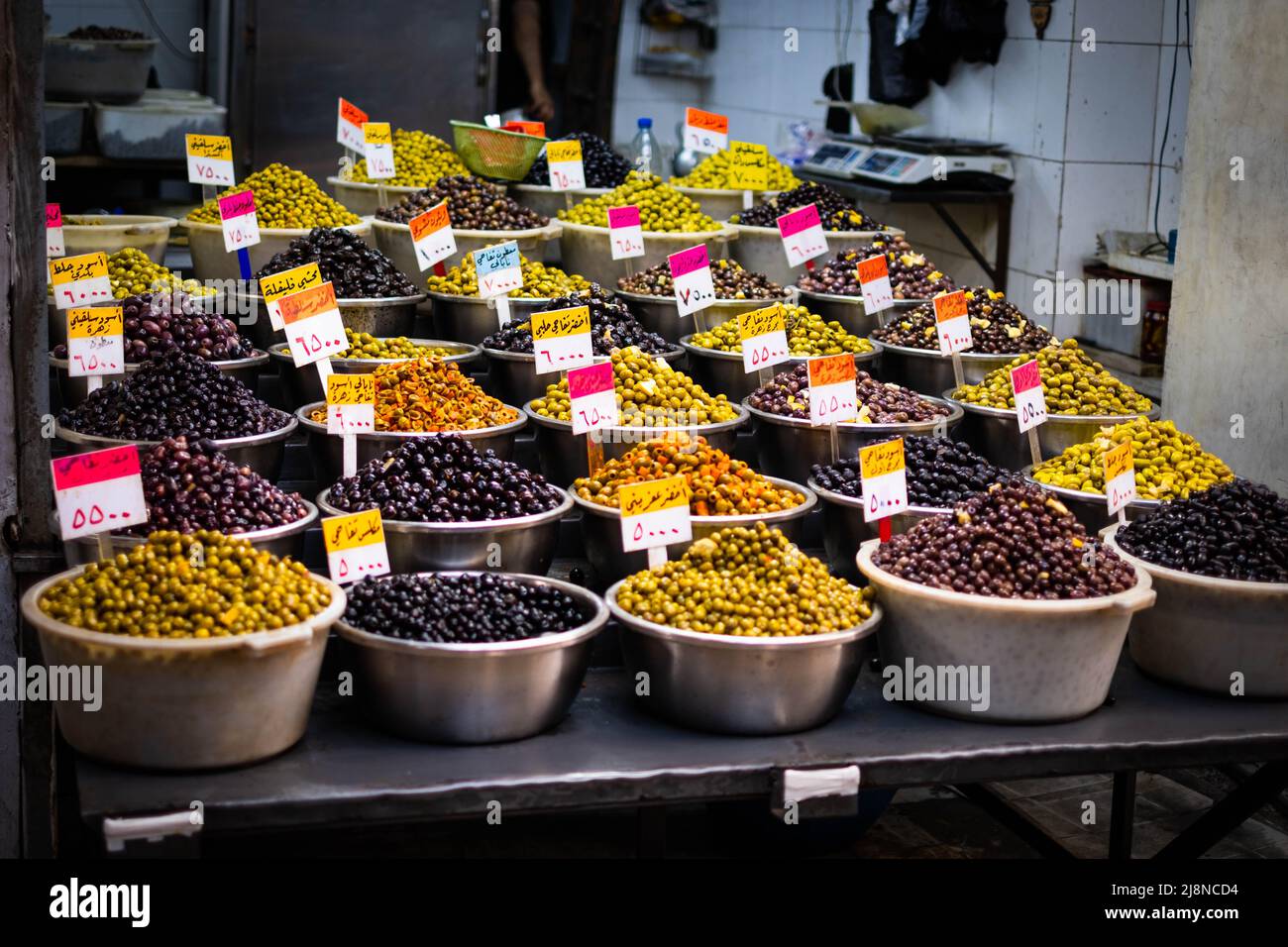 Variety of olives for sale on Suq (arabic price tags Stock Photo - Alamy
