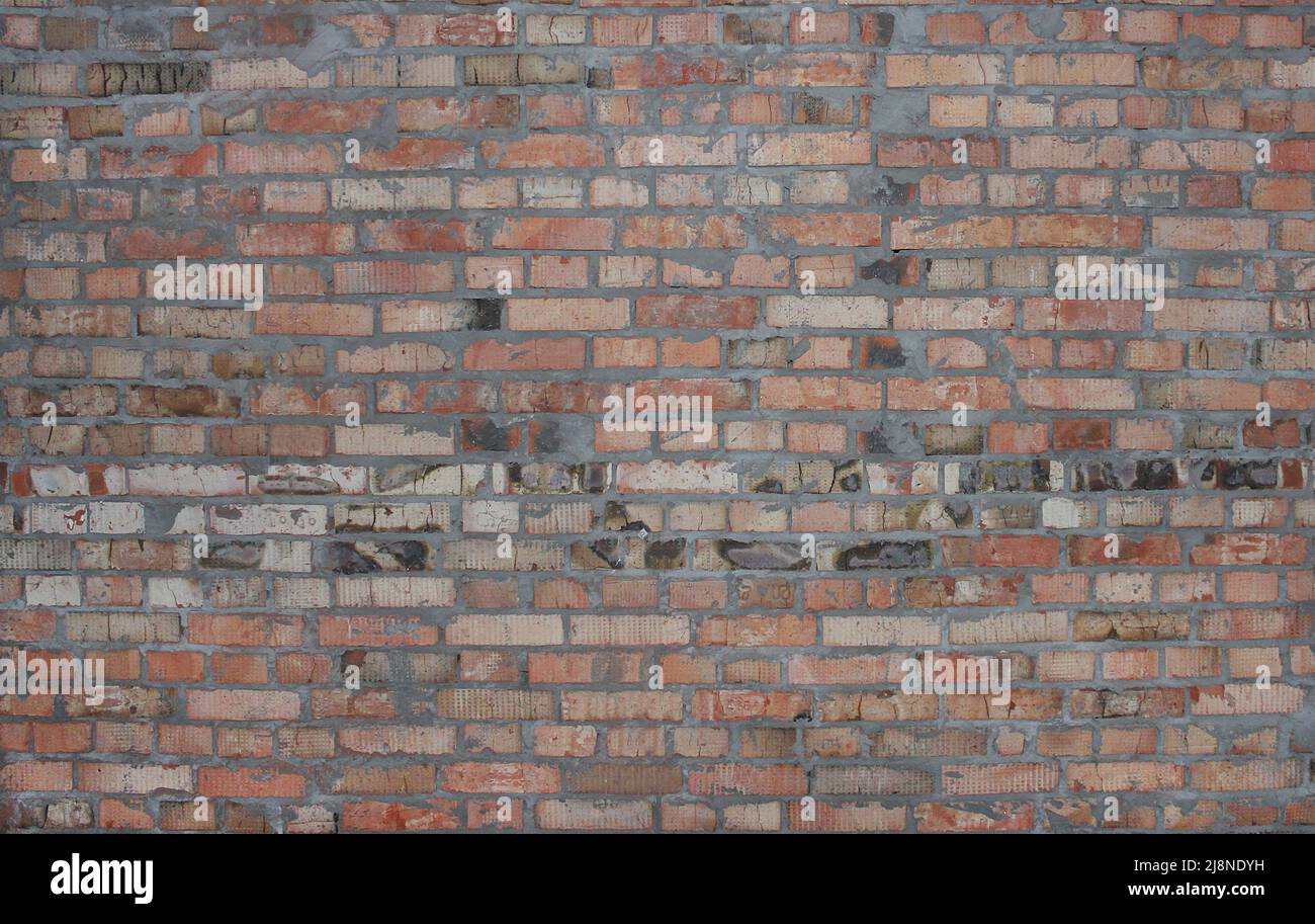 Wall of red plinth bricks as a background Stock Photo - Alamy