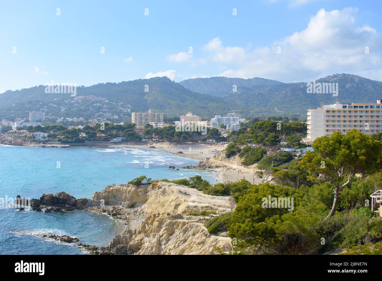 Waterside view of turquoise sea water and rocky coastline of Peguera ...