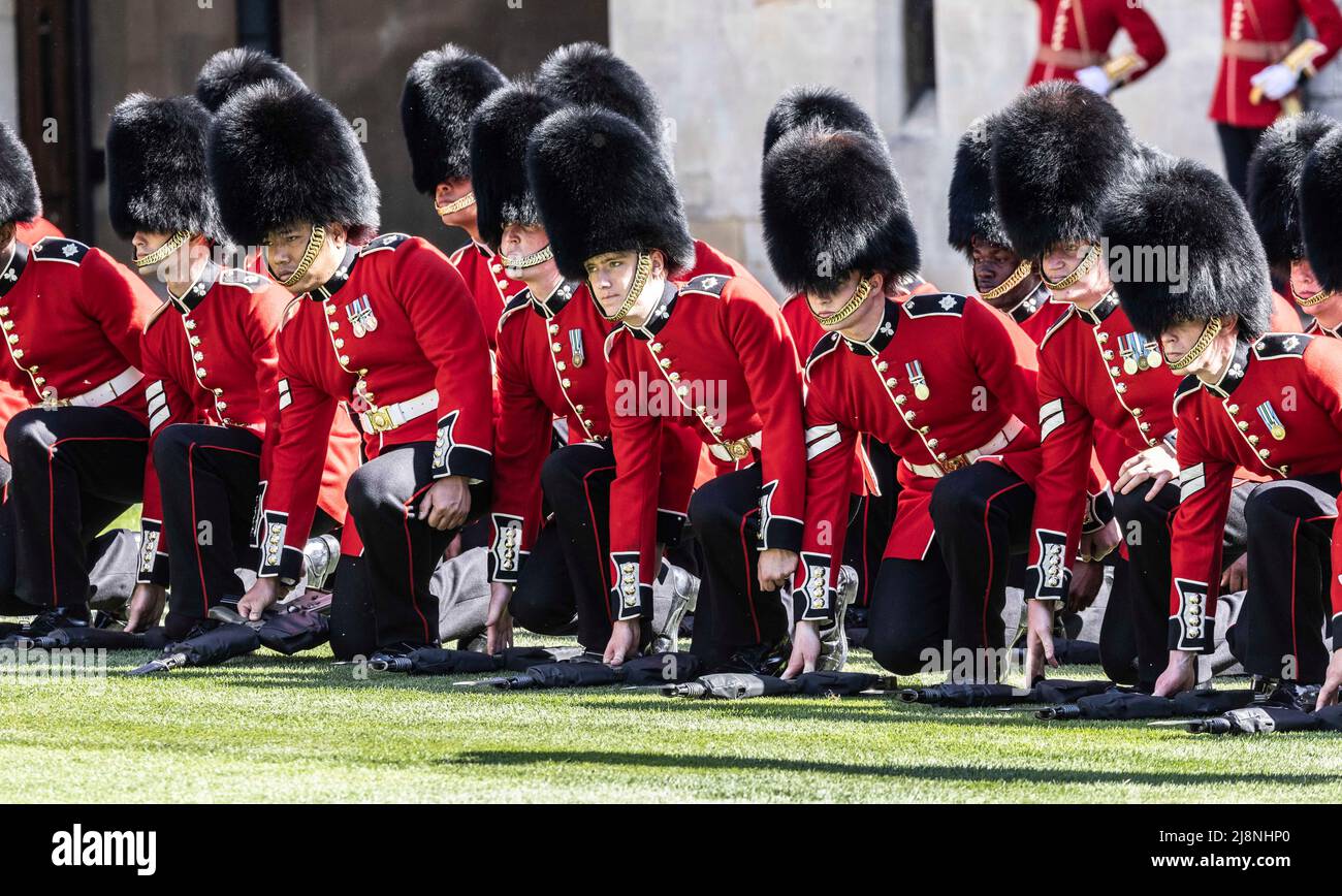 Guardsmen of the 1st battalion Irish guards lay their weapons on the ground before giving three ...