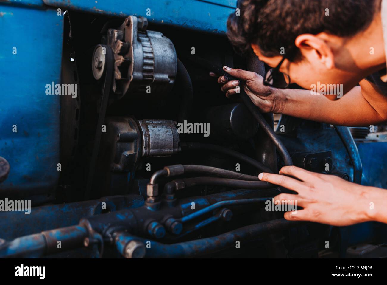 Fixing tractor old man hi-res stock photography and images - Alamy