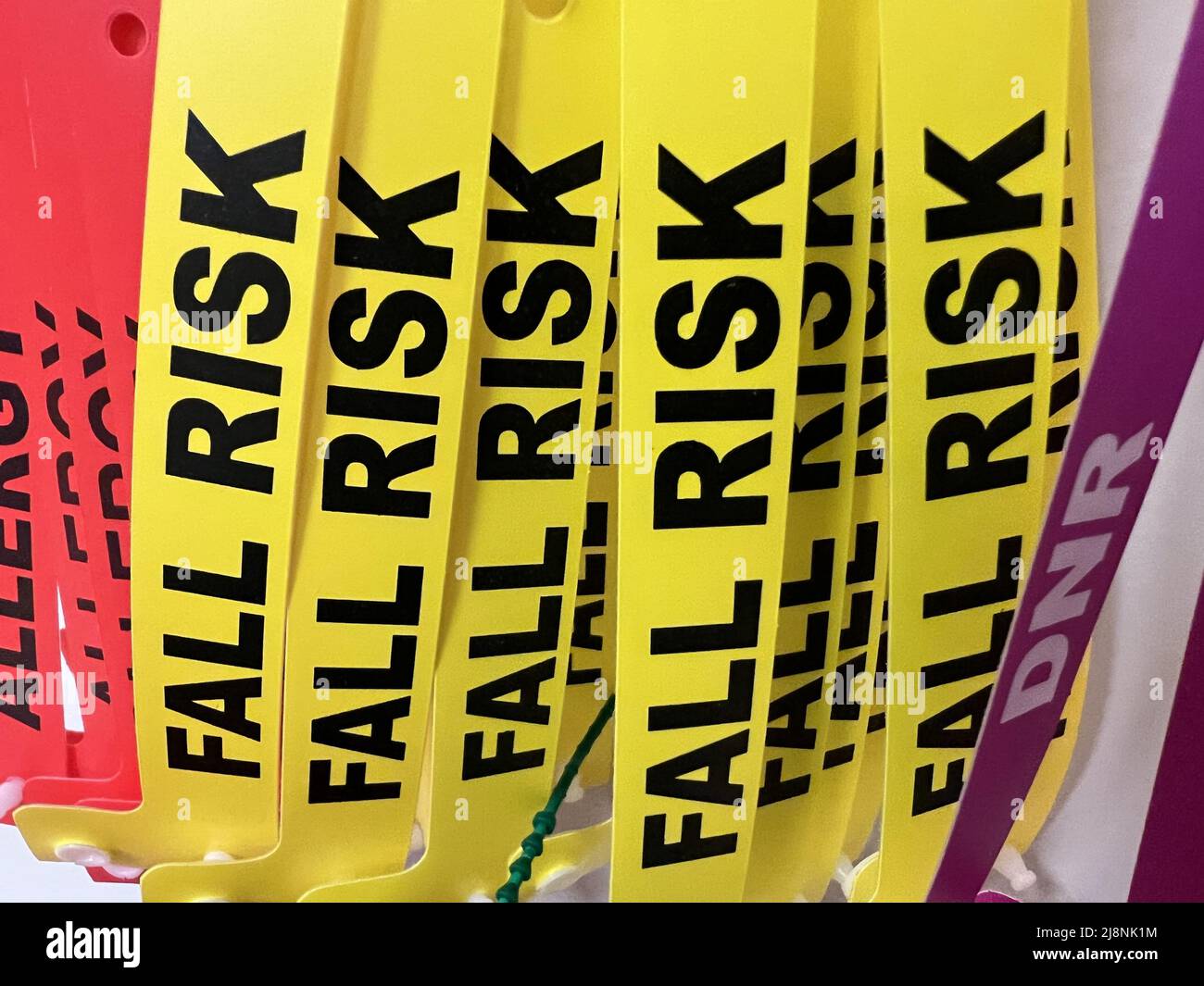Yellow wristbands reading Fall Risk in a hospital emergency room in ...