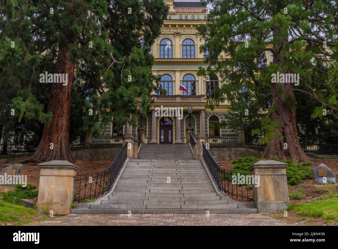 School in Banska Stiavnica town in cloudy day after rain with big ...