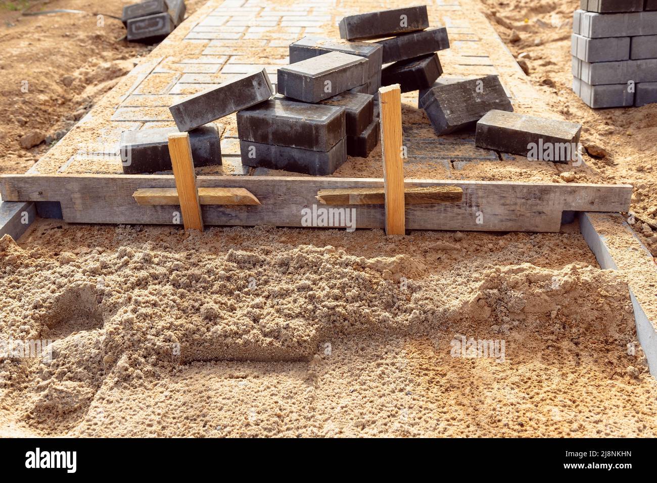 Laying the path with paving bricks. Street improvement. Construction of ...