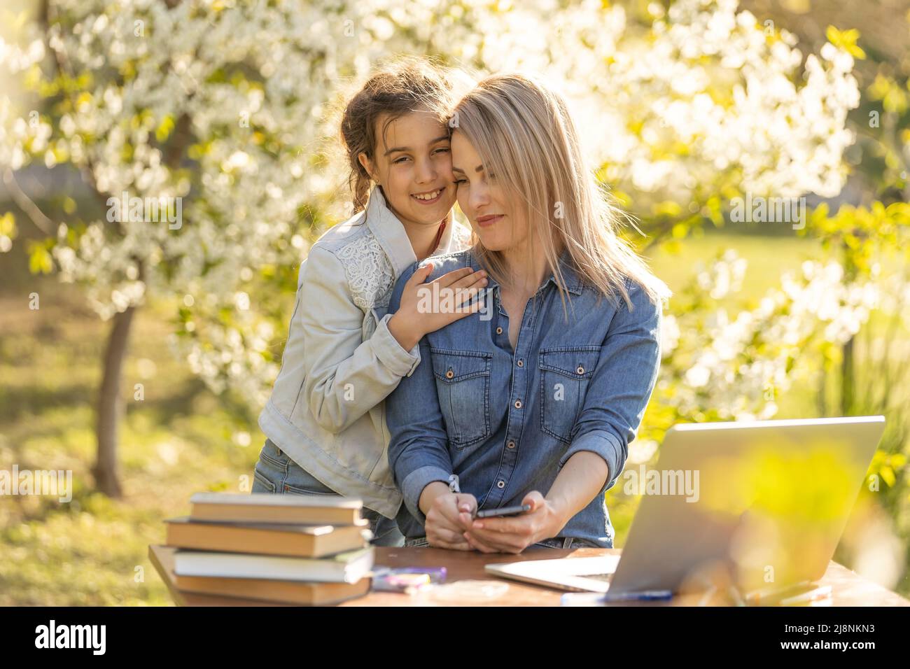 little girl with mom learning on laptop outdoor Stock Photo - Alamy