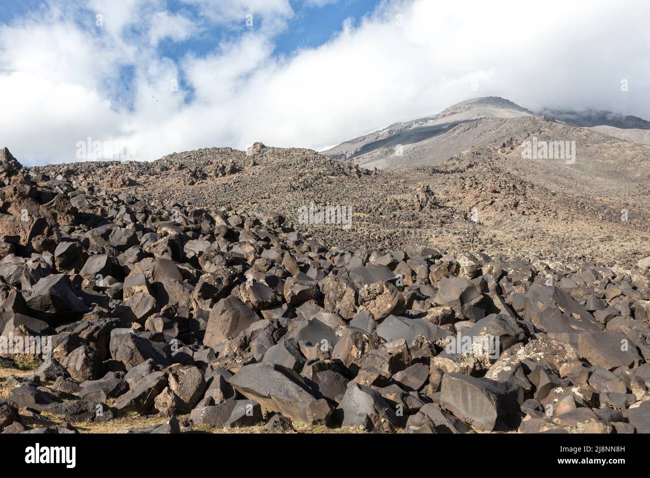 Basalt volcanics rocks and stones on the tourist hike path in mountains ...