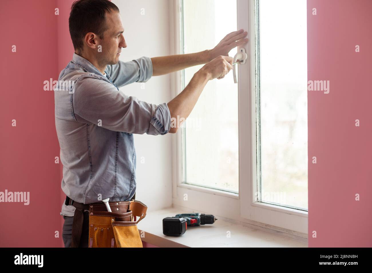 The worker installing and checking window in the house Stock Photo - Alamy