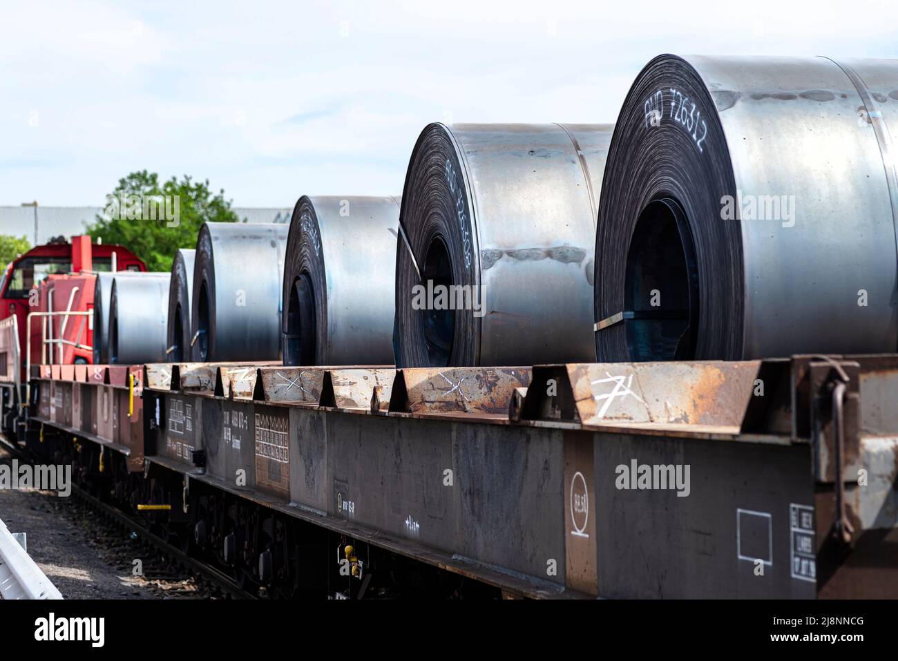Large rolls of sheet metal lying on a freight wagon pulled by ...