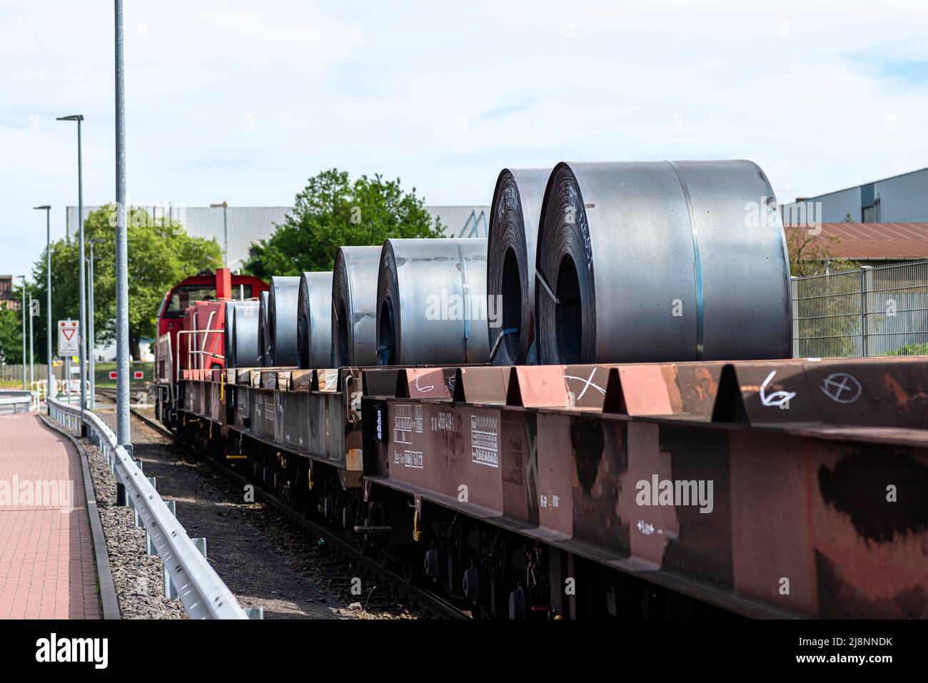 Large rolls of sheet metal lying on a freight wagon pulled by ...