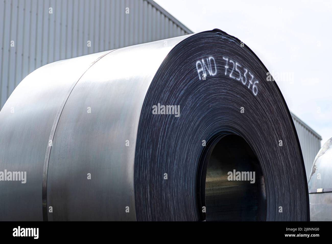 Large rolls of sheet metal lying on a freight wagon pulled by ...