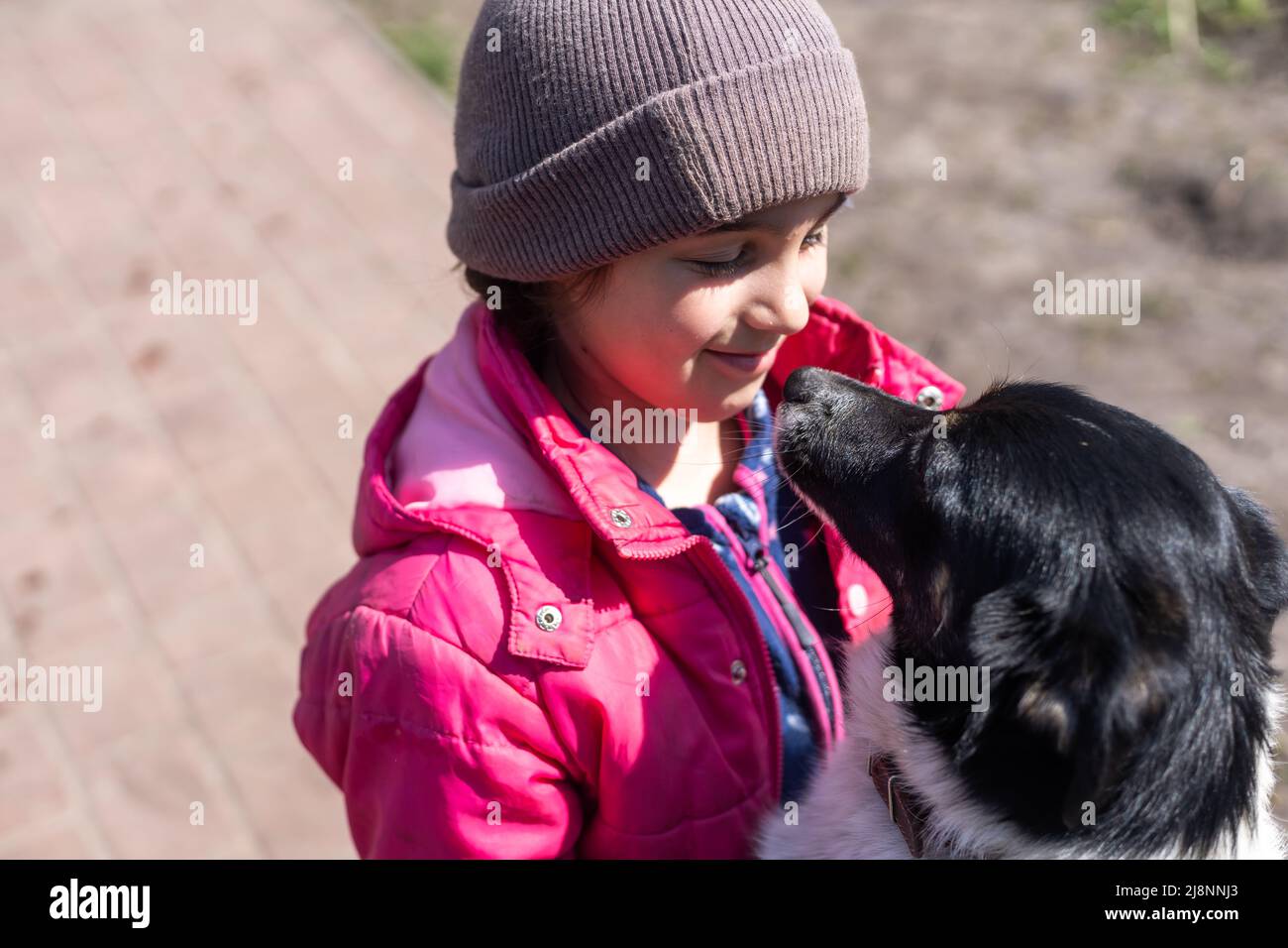 poor little girl with a dog in village Stock Photo - Alamy