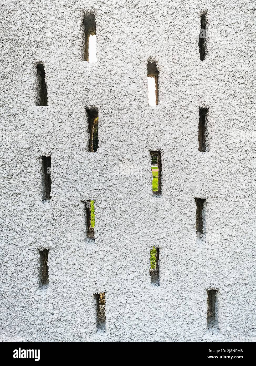 Part of big concrete fence in park with small oblong holes inside Stock ...