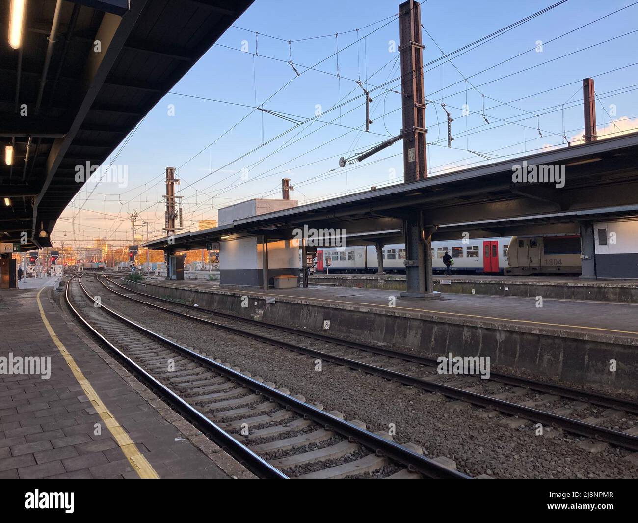train station in the evening with the sky turning orange and no people ...