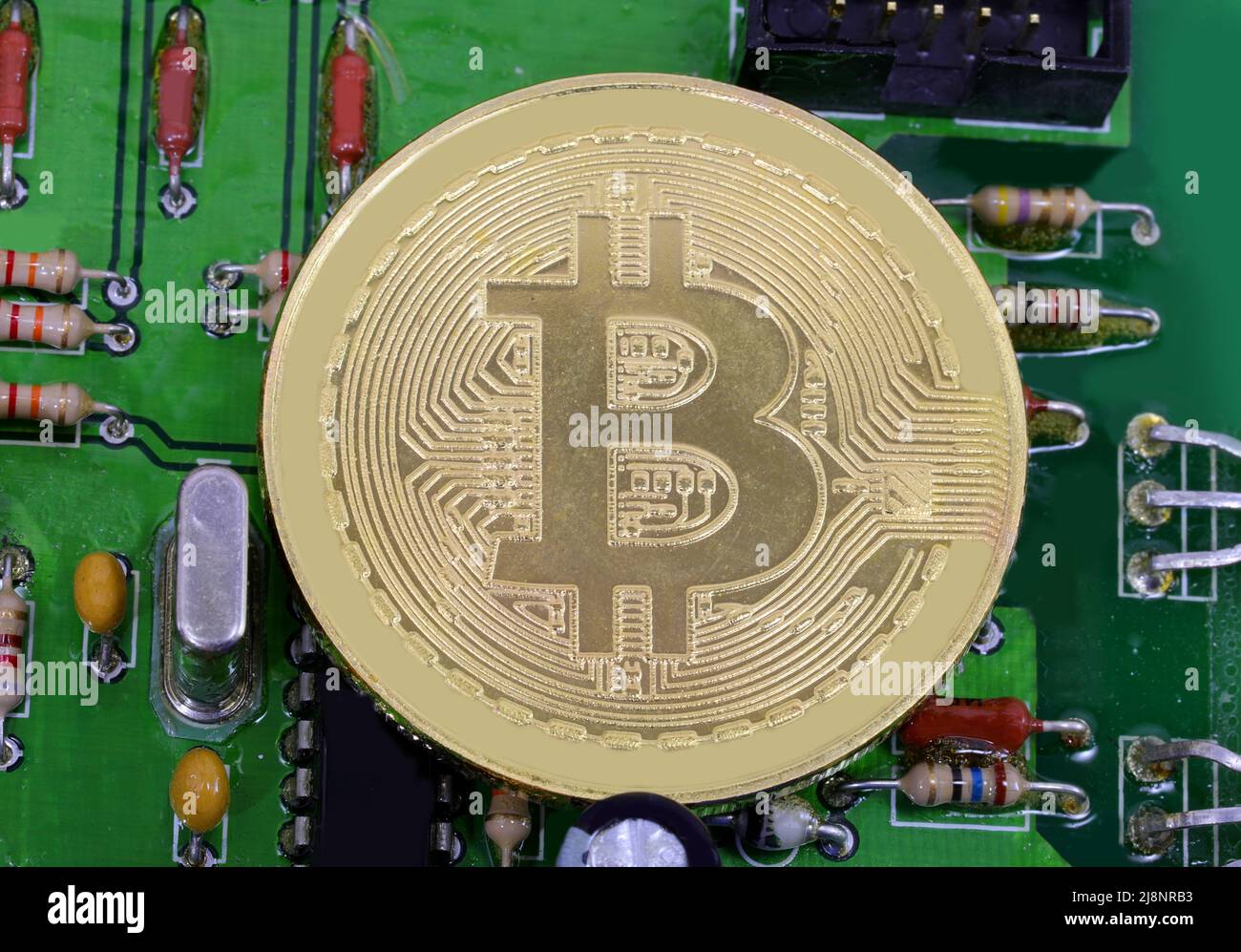 golden coin with the symbol of the cryptocurrency bitcoin in the middle ...