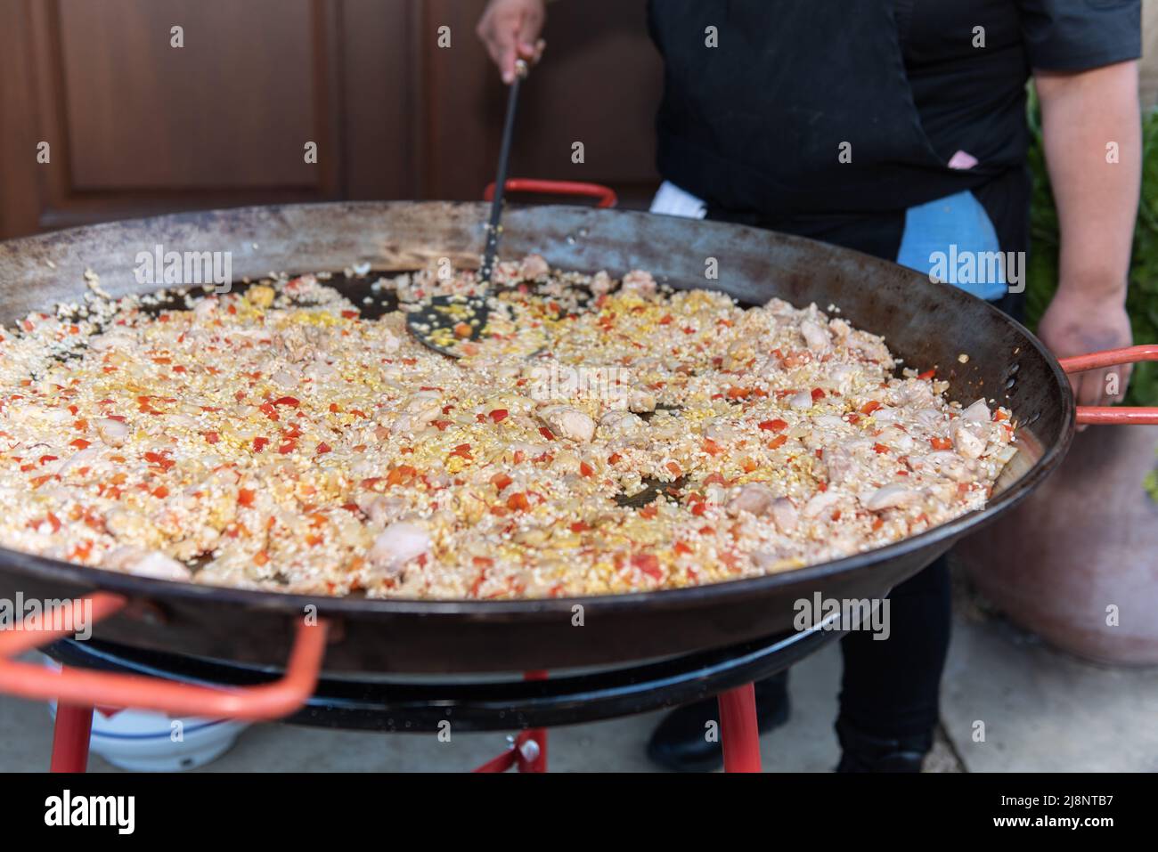 Enormous batch of paella being cooked in the extra large wok for the ...